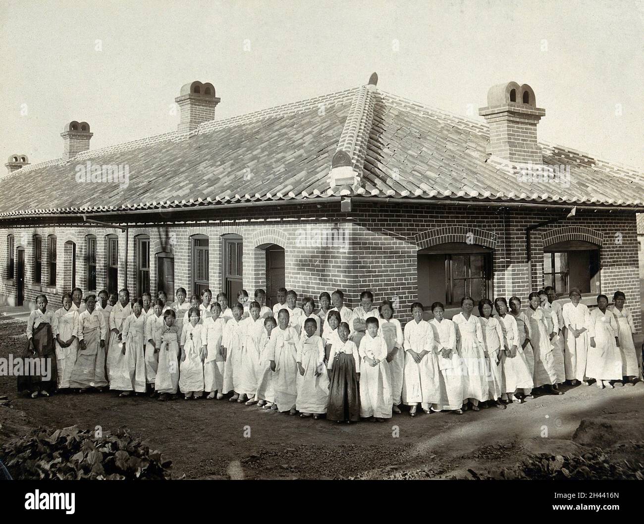 Leper asylum, Taiku, Korea: female patients wearing white robes stand ...