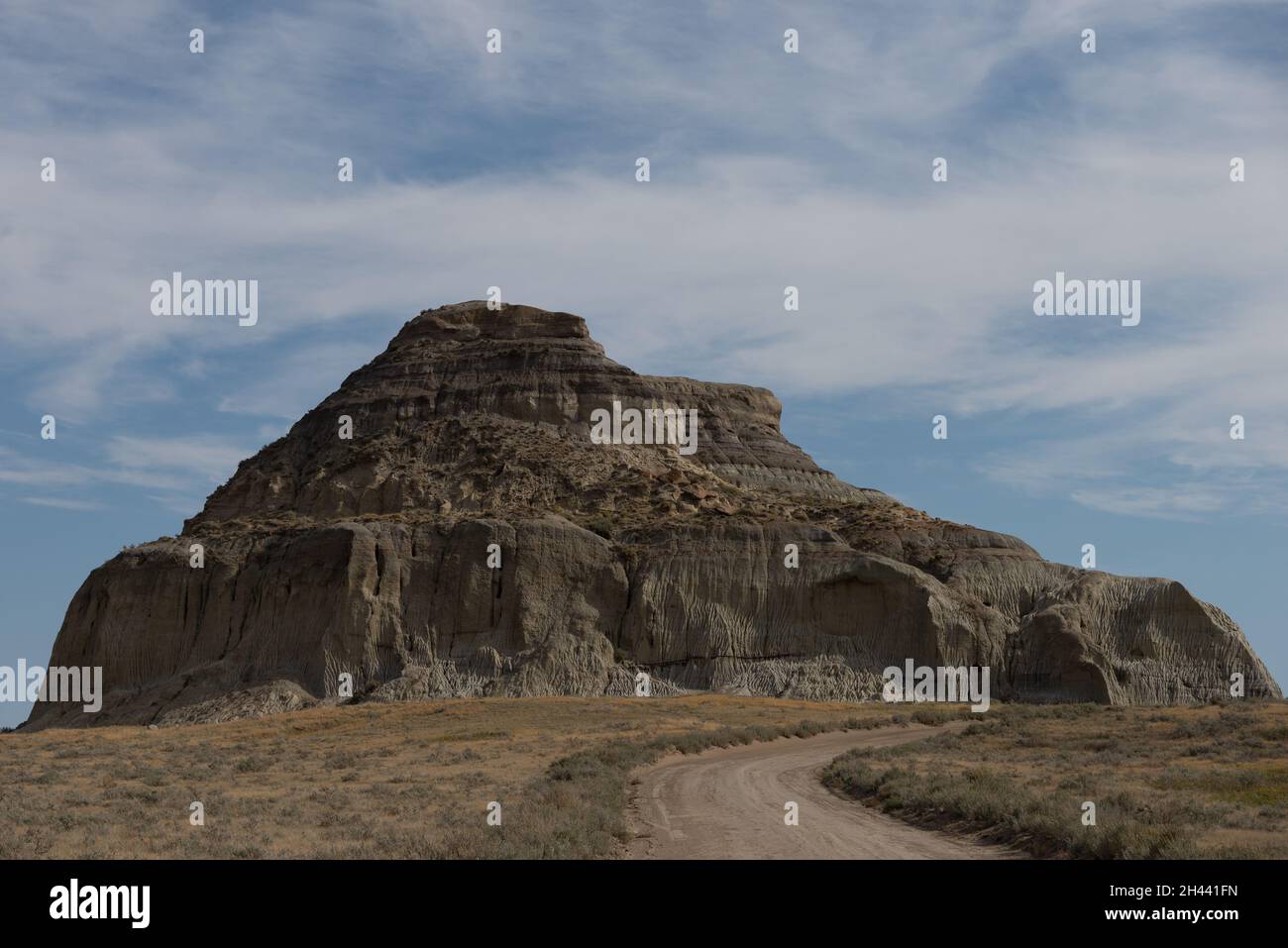 A low angle shot of a rocky mountain with the background of blue sky ...