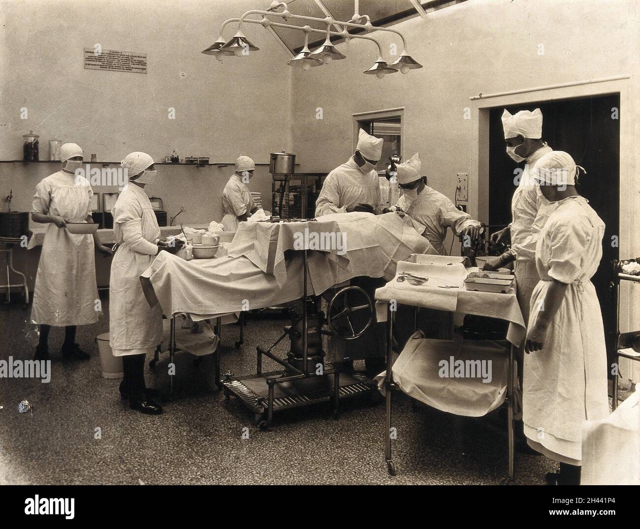 An operating theatre: surgical staff performing an operation ...