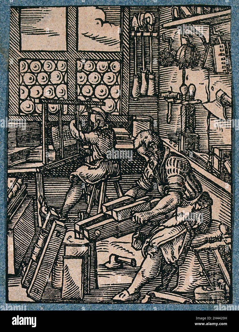 Two men are working on wood at their benches in the workshop. Woodcut ...