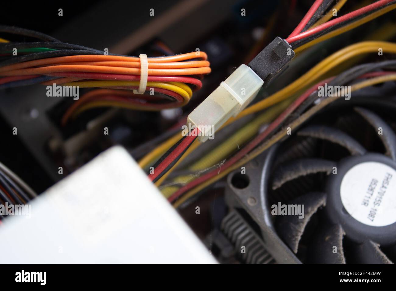 Man hand putting electrical connections of a computer in right sockets ...