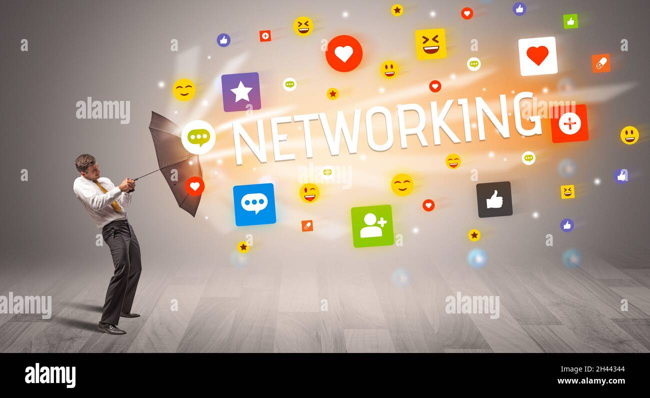 businessman defending with umbrella from social media Stock Photo - Alamy