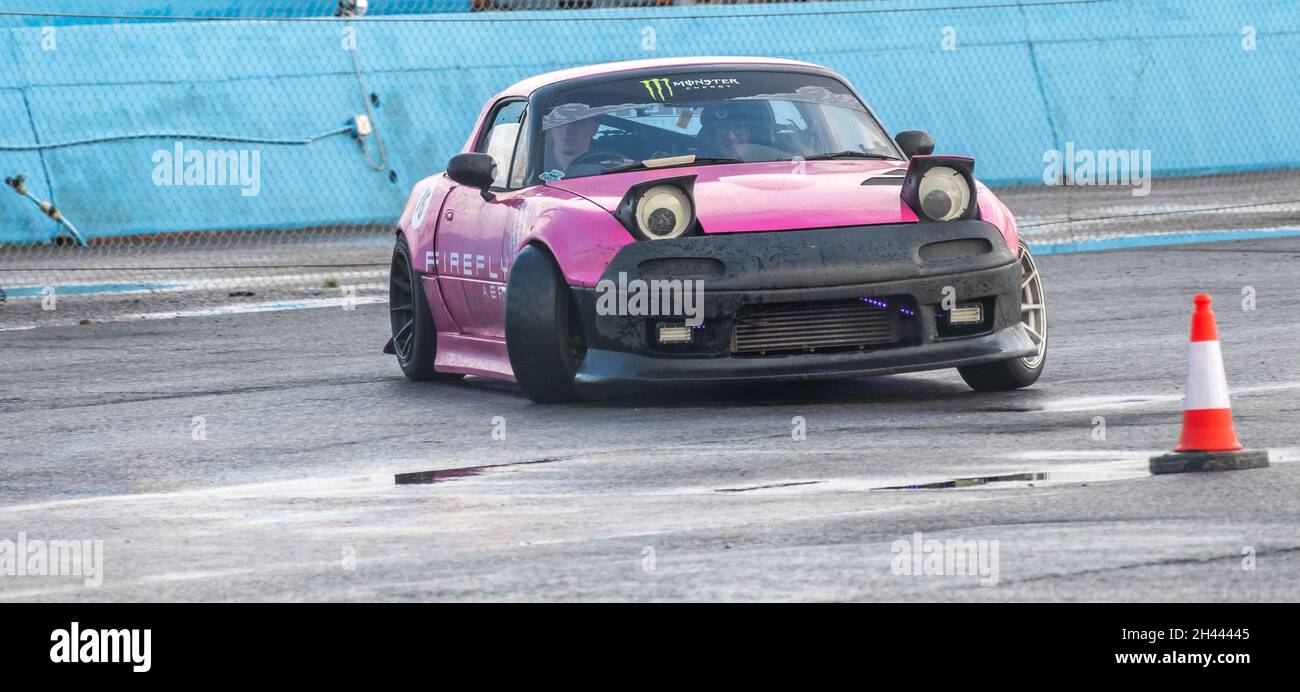 Classic rear wheel drive Mazda MX-5 car drifting, with a passenger ...