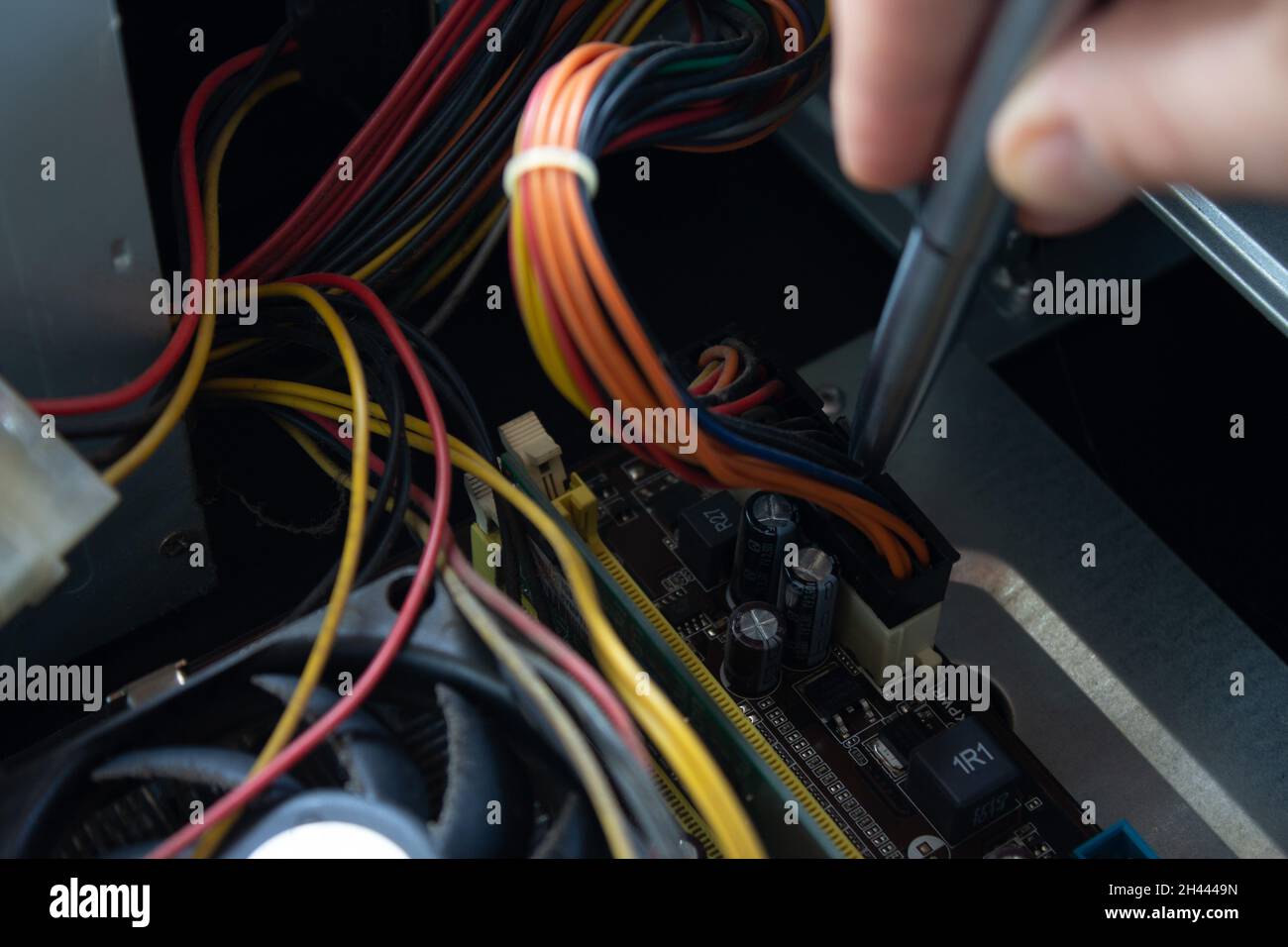 Man hand pointing out some computer pieces in a old dusty and dirty ...