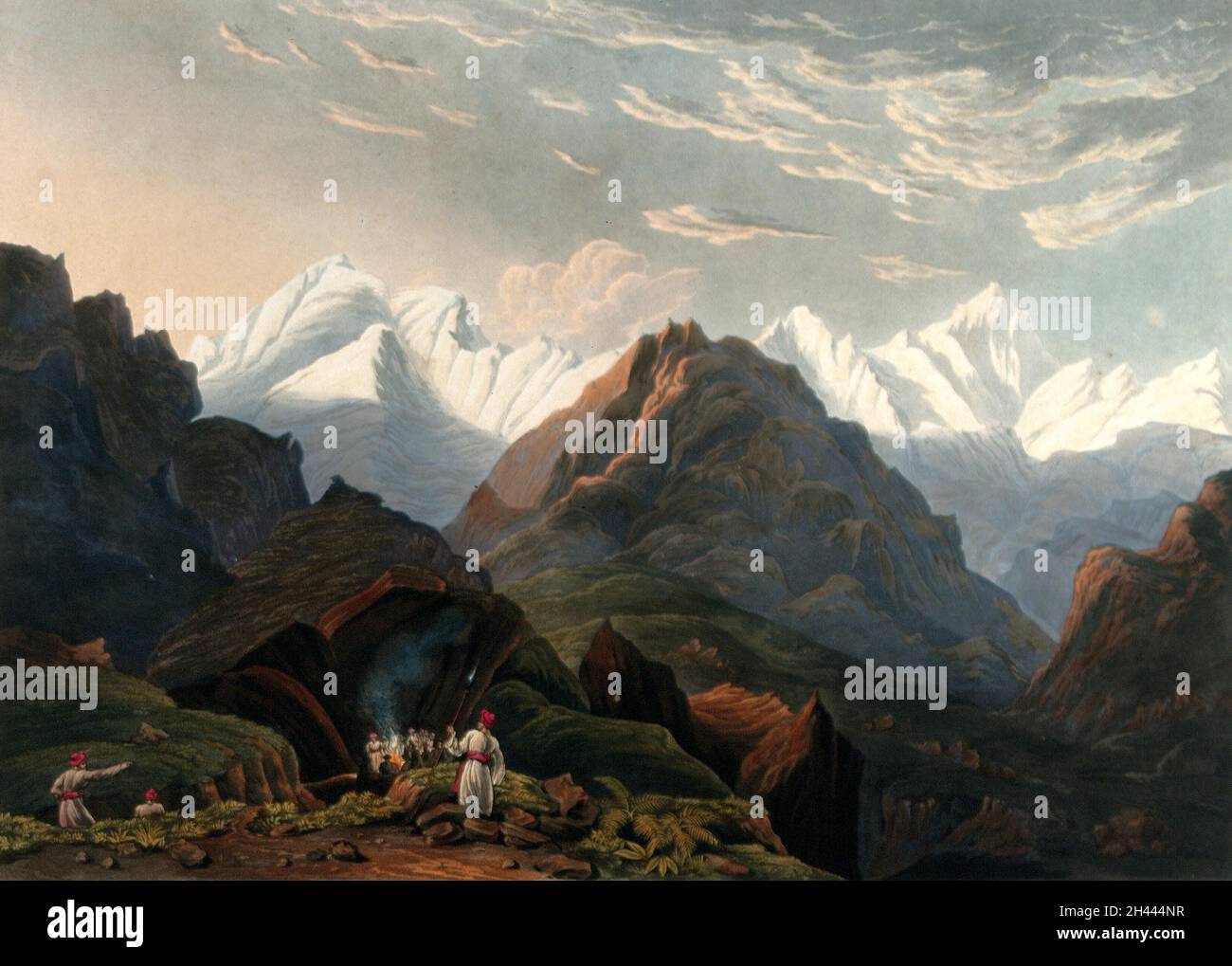 View of the mountains; a man pointing to the far distance as others sit ...