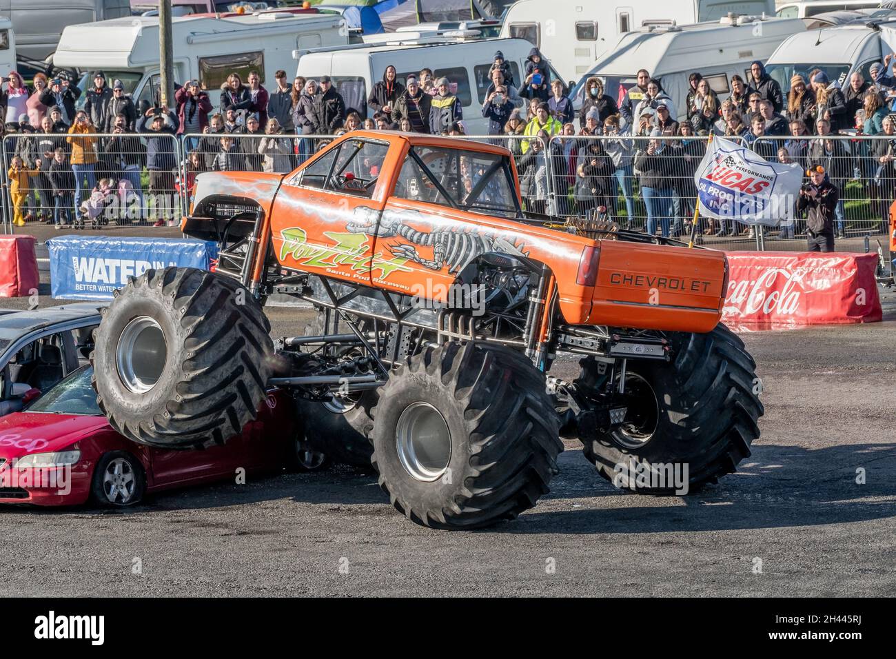 The Podzilla monster truck jumping cars during a live performance at ...