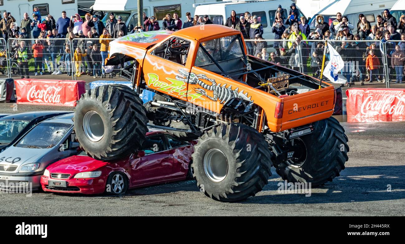 The Podzilla monster truck jumping cars during a live performance at ...