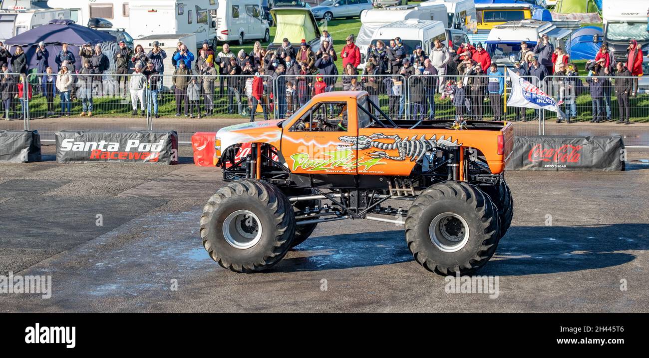 The Podzilla monster truck jumping cars during a live performance at ...