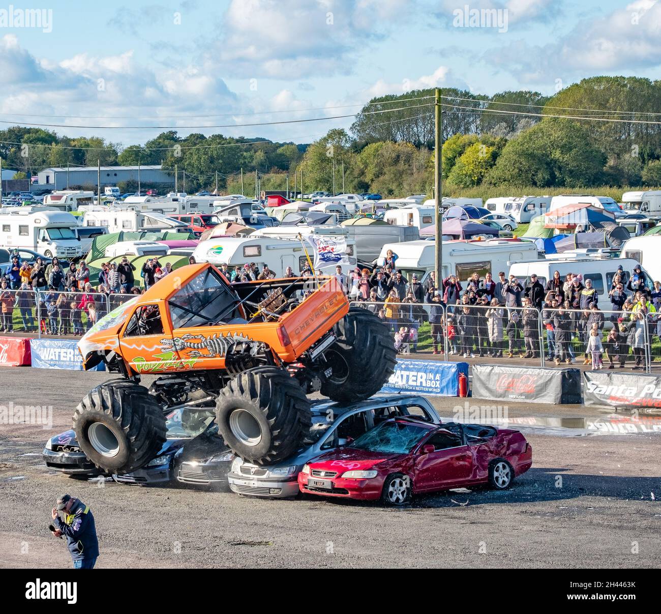 The Podzilla monster truck jumping cars during a live performance at ...