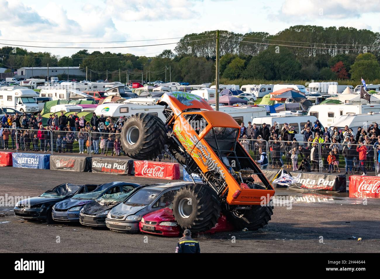 The Podzilla monster truck jumping cars during a live performance at ...