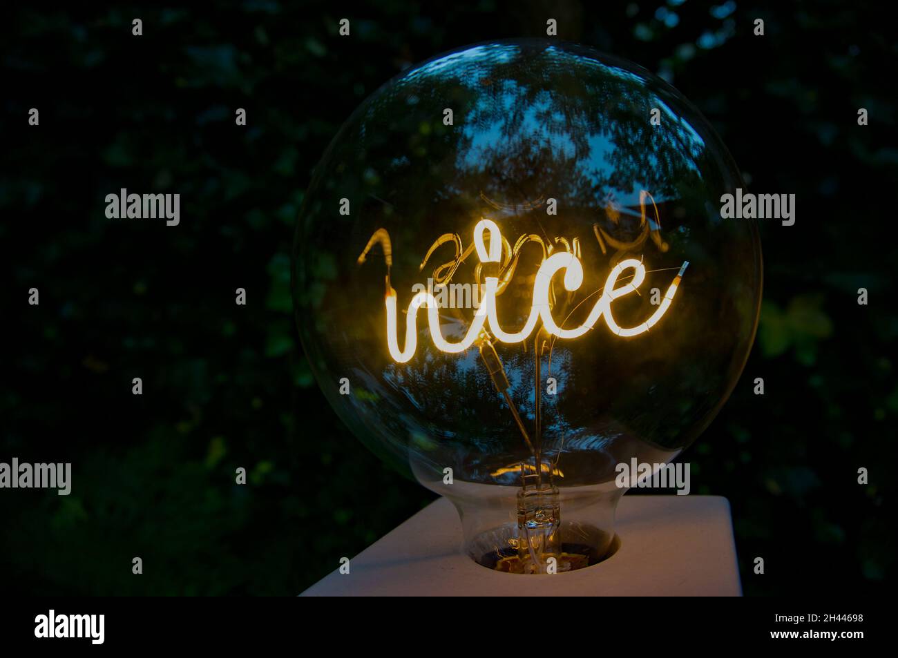 Light bulb with the text nice. In the garden Stock Photo - Alamy