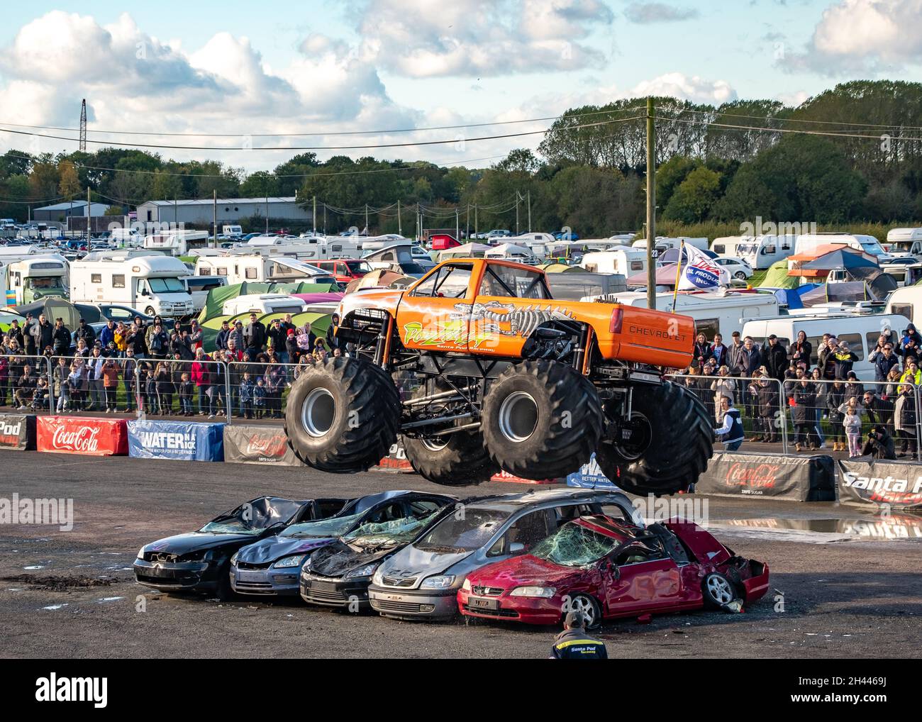 The Podzilla monster truck jumping cars during a live performance at ...