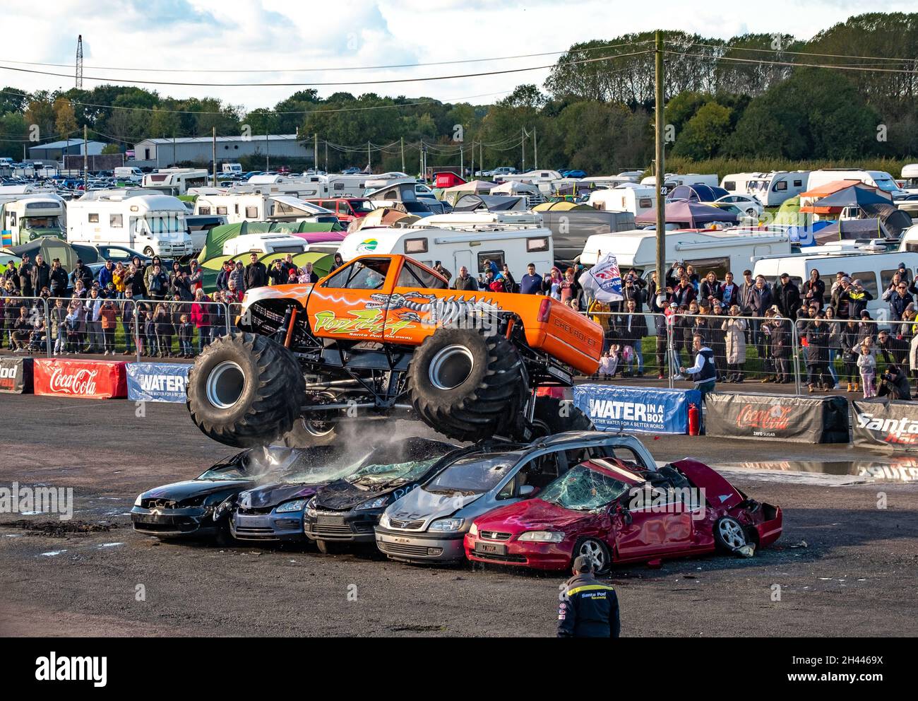 The Podzilla monster truck jumping cars during a live performance at ...