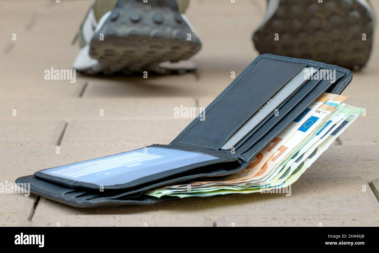 Lost wallet, with banknotes lies on the street Stock Photo - Alamy