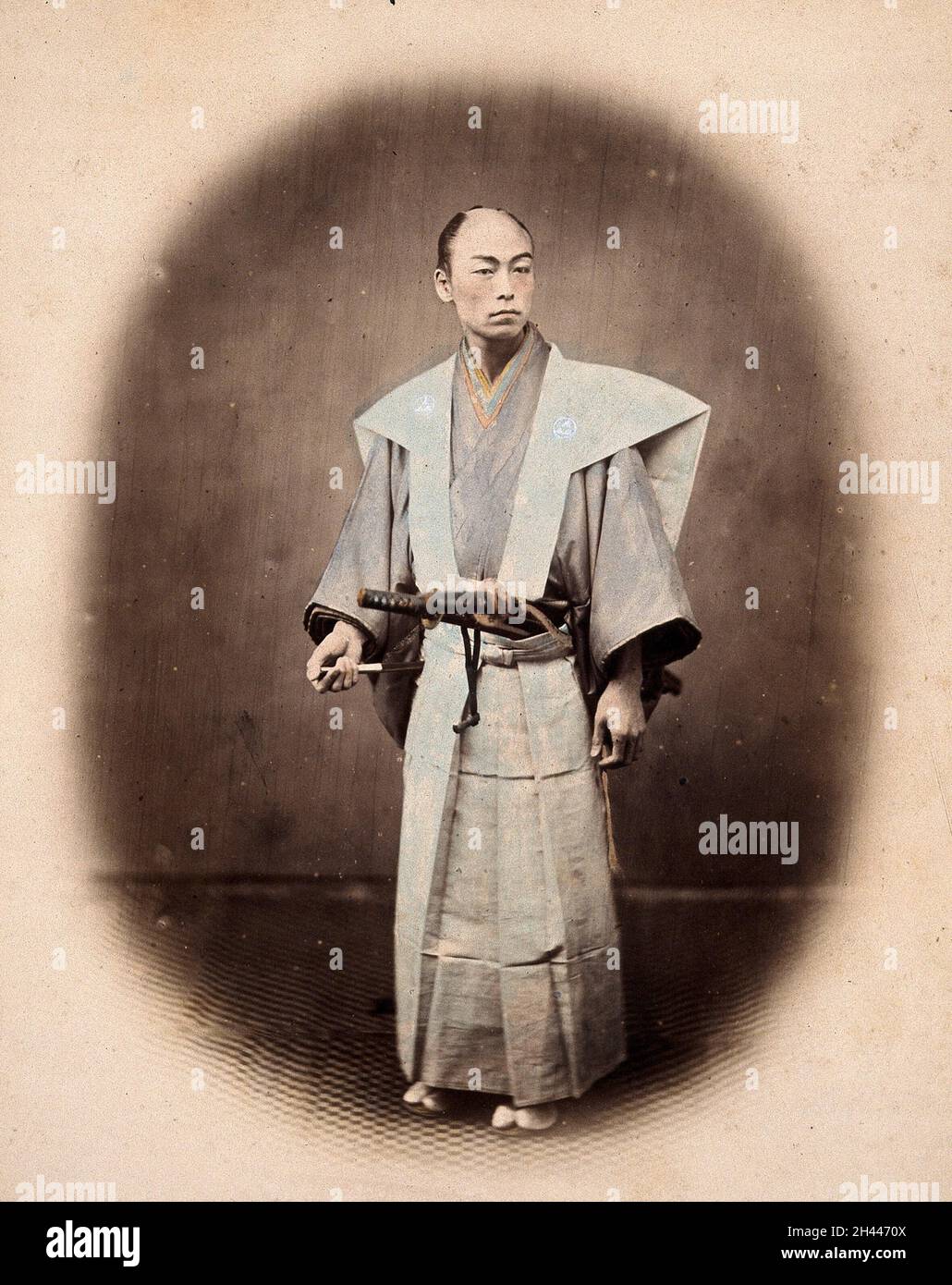 Japan: a samurai (a 'yakonin') in ceremonial dress. Coloured photograph ...