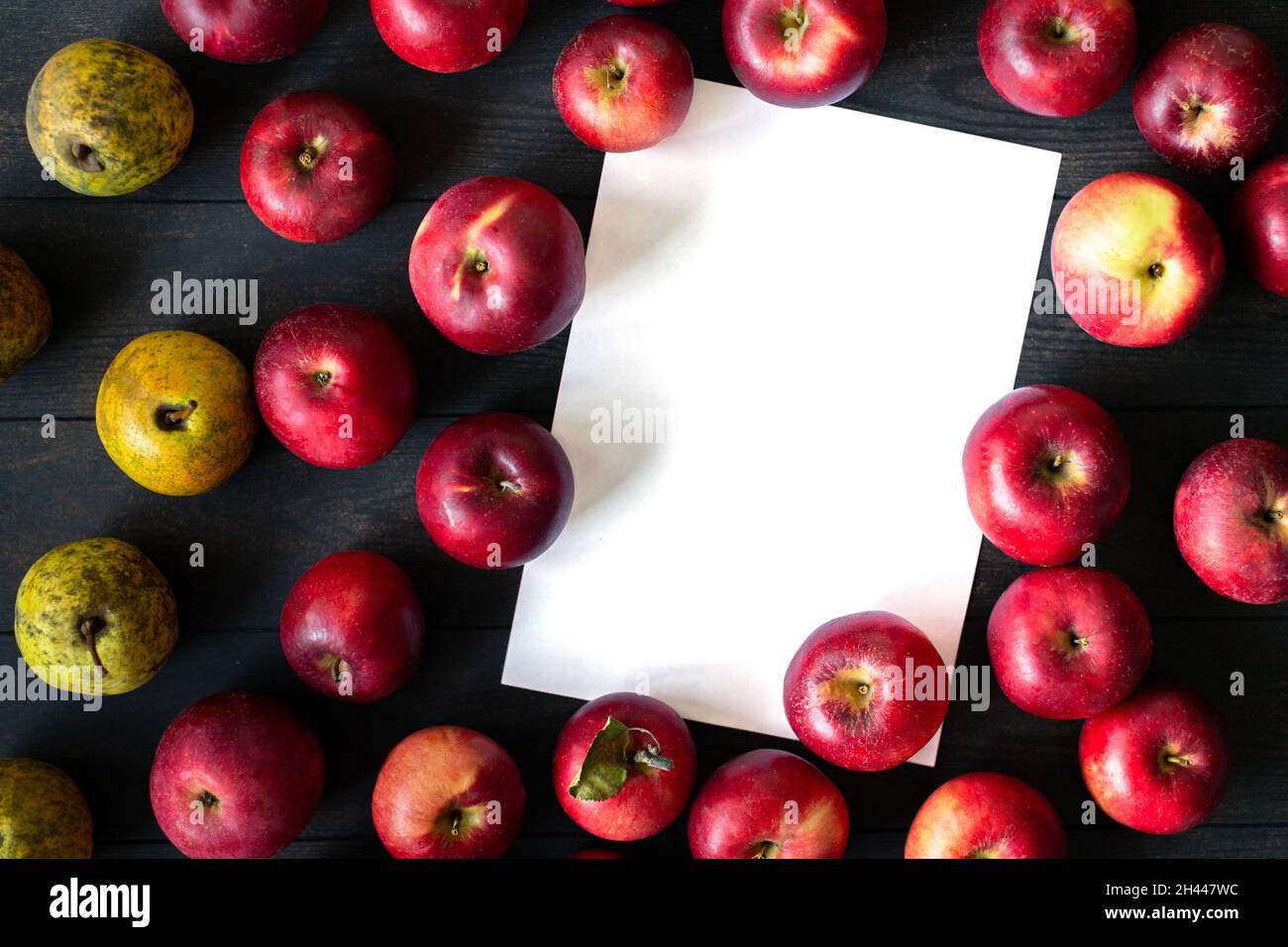 Imperfect red apples and yellow pears on a dark background. Bulk. Top ...