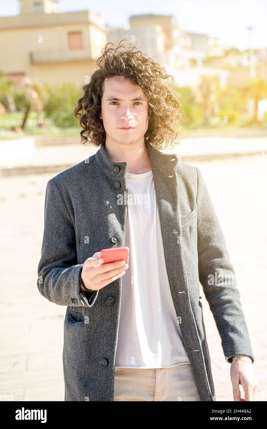 cute young man look direct into camera using phone Stock Photo - Alamy