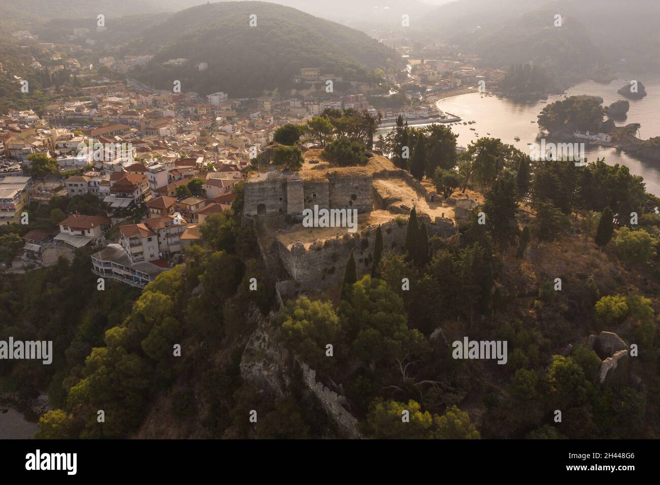 Aerial shot of medieval fort on mountain at the port town of Parga in ...