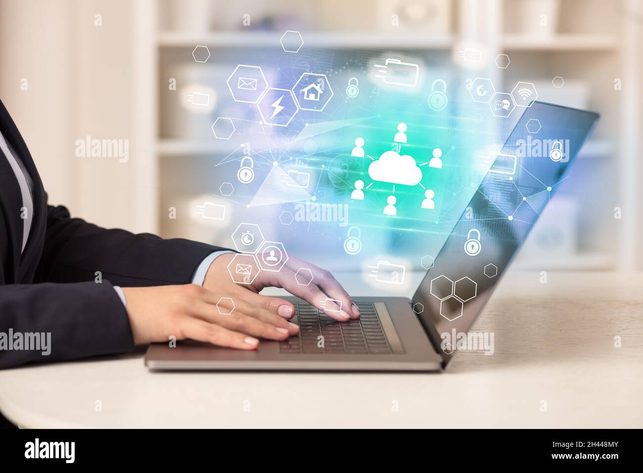 Hands working on laptop with digital icons Stock Photo - Alamy