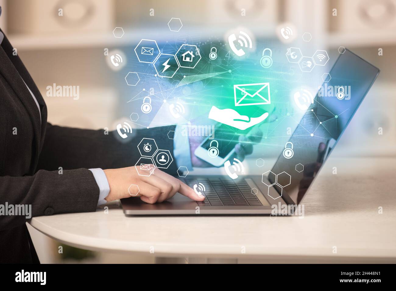 Hands working on laptop with digital icons Stock Photo - Alamy