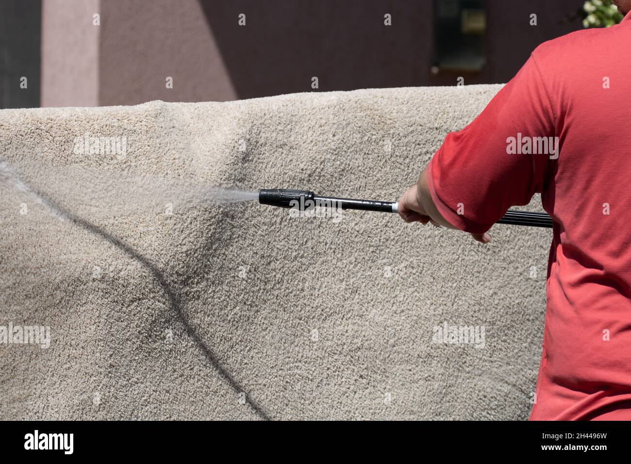 Washing carpets with high pressure washer. Cleaning the carpet with a ...