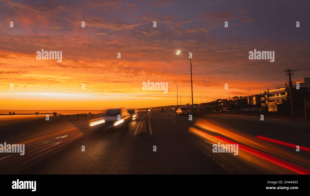 The traffic road with moving cars against a cloudy sky at sunset Stock ...