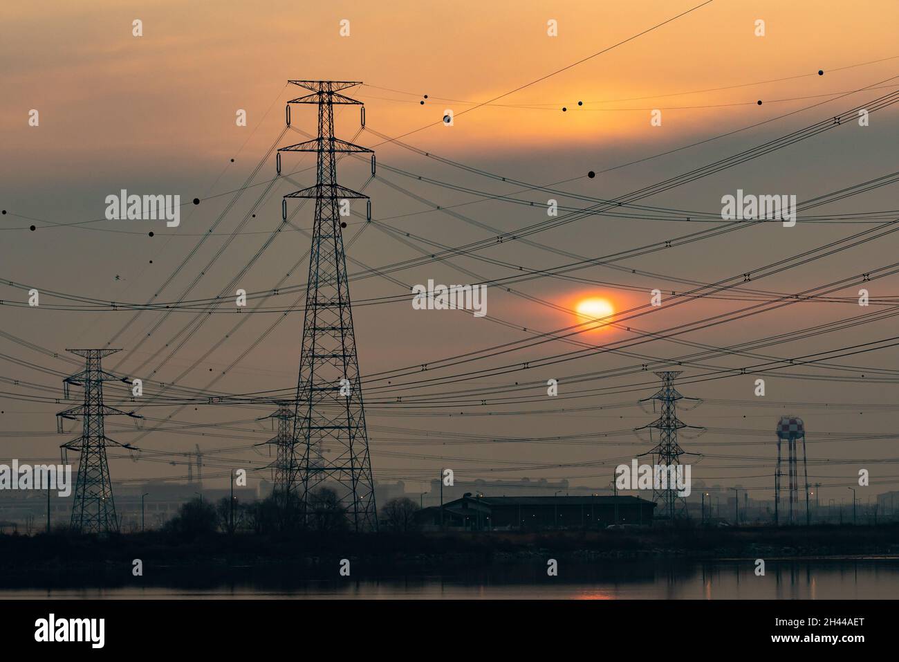 A mesmerizing sunset view over the crossing cords of high voltage ...