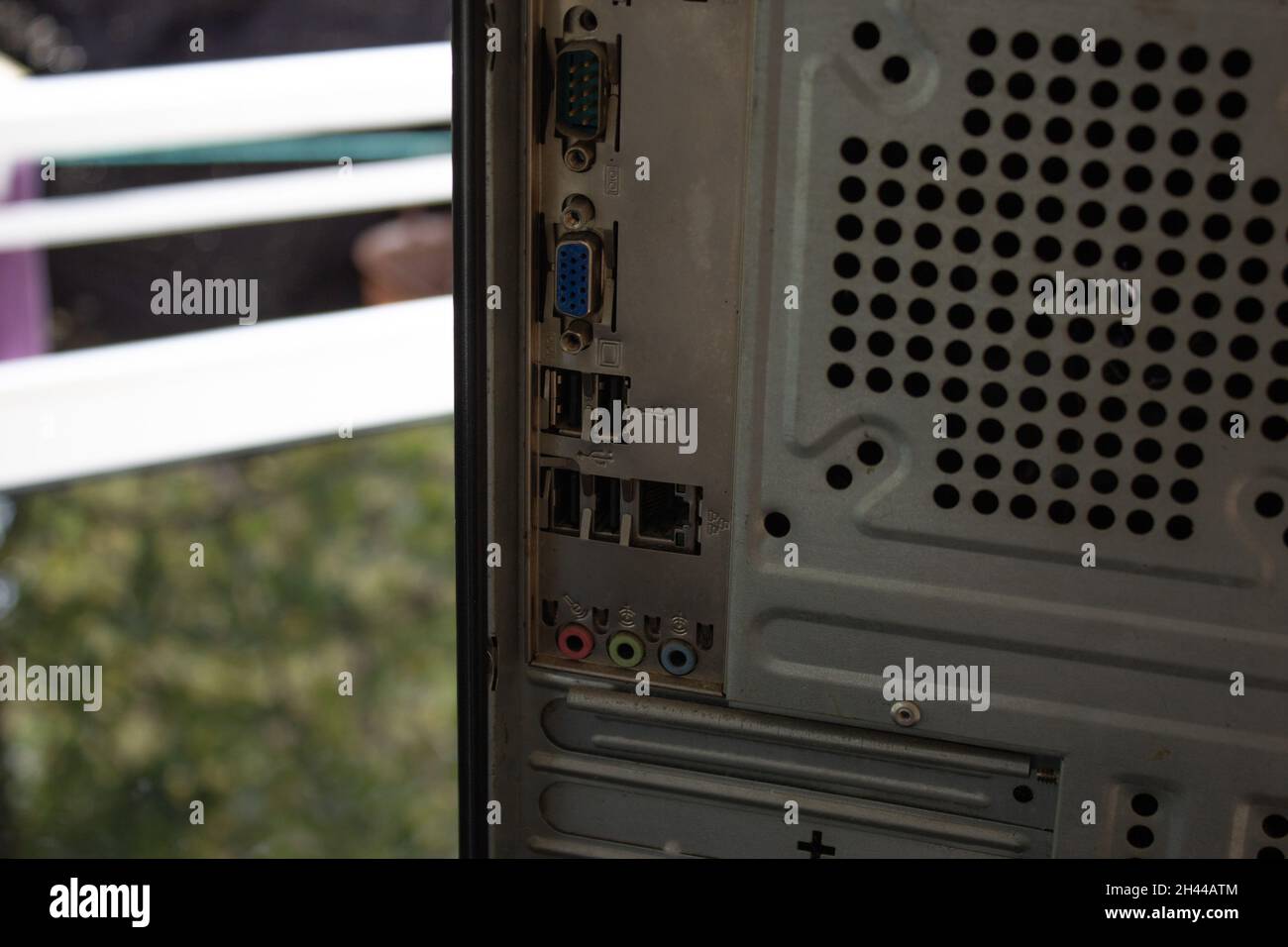 The back side of a computer with sockets, cables, and a bitcoin holding ...