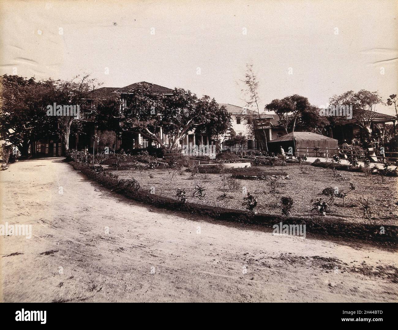 A curved pathway past a small garden, probably leading to a plague ...