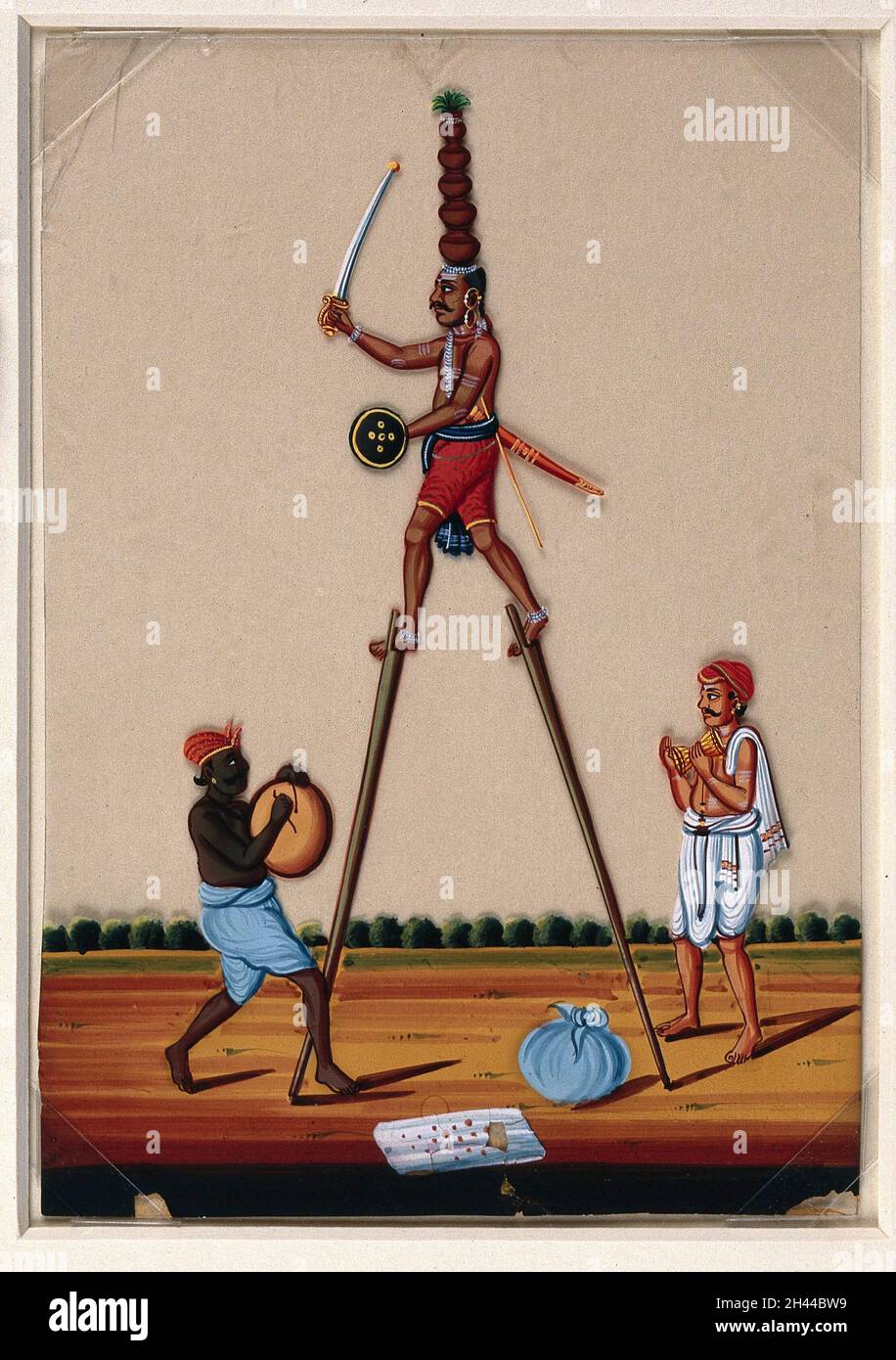 Street performers: an acrobat on stilts while the other two provide ...