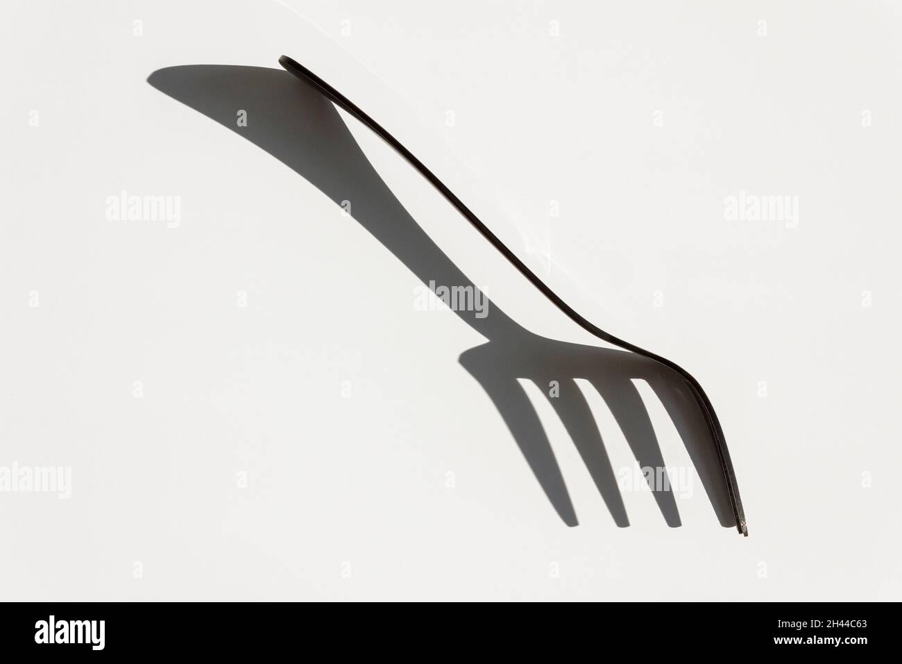 Fork with sharp shadows of sun on a white background. Menu design ...