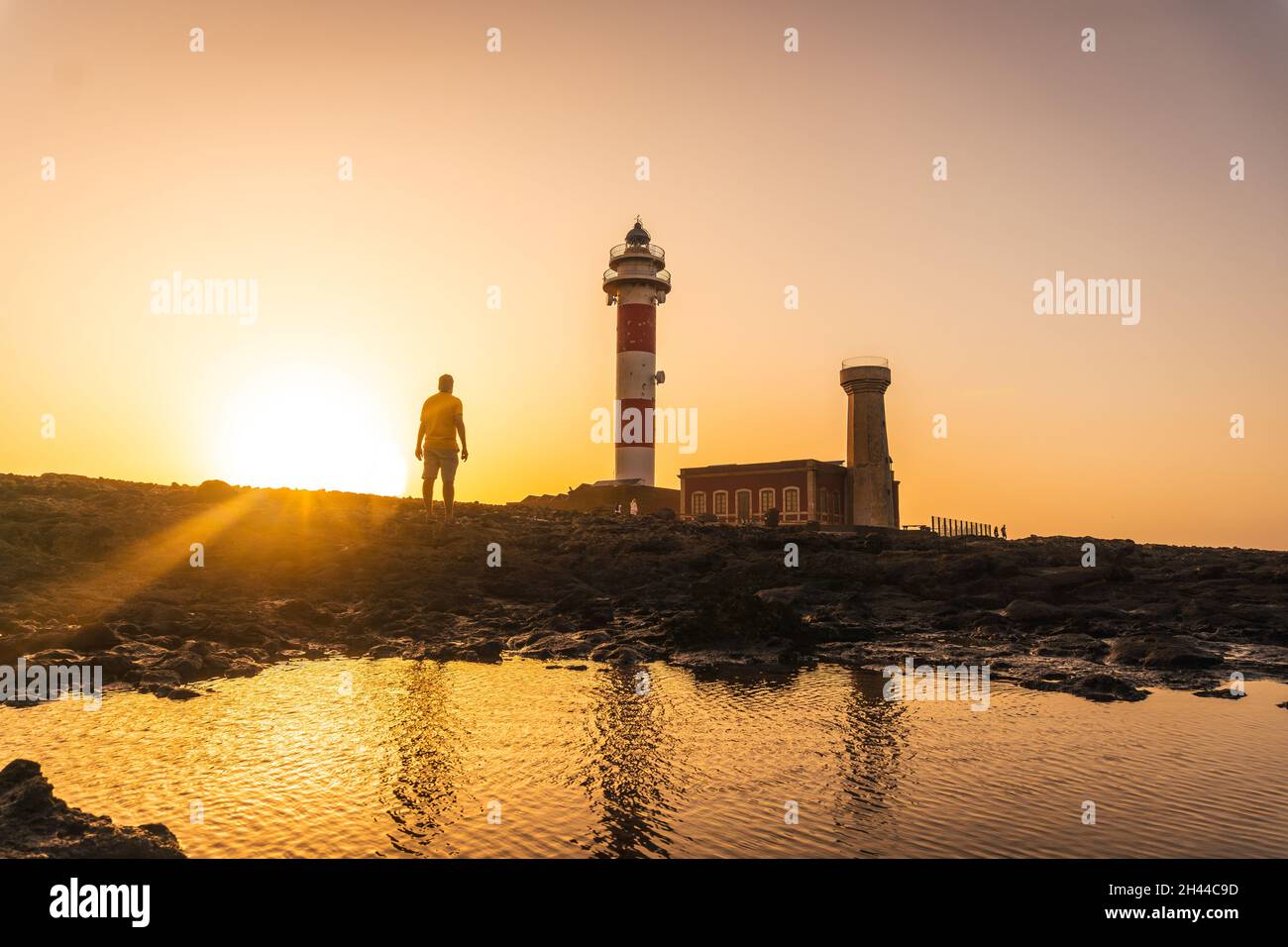 A silhouette of a male standing near the Toston Lighthouse in Punta ...