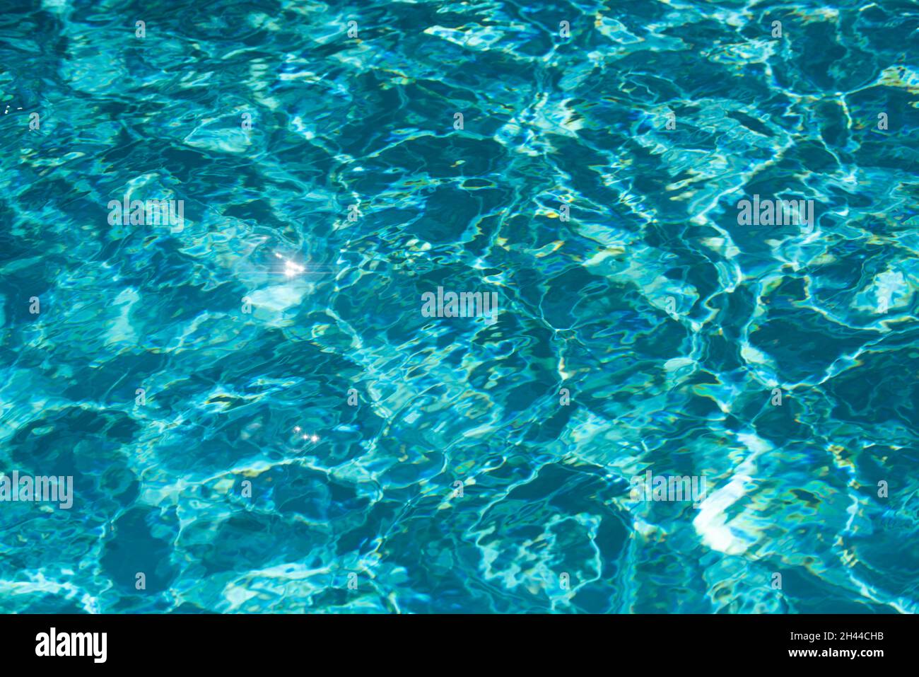 Abstract ripple wave and clear turquoise water surface in swimming pool ...
