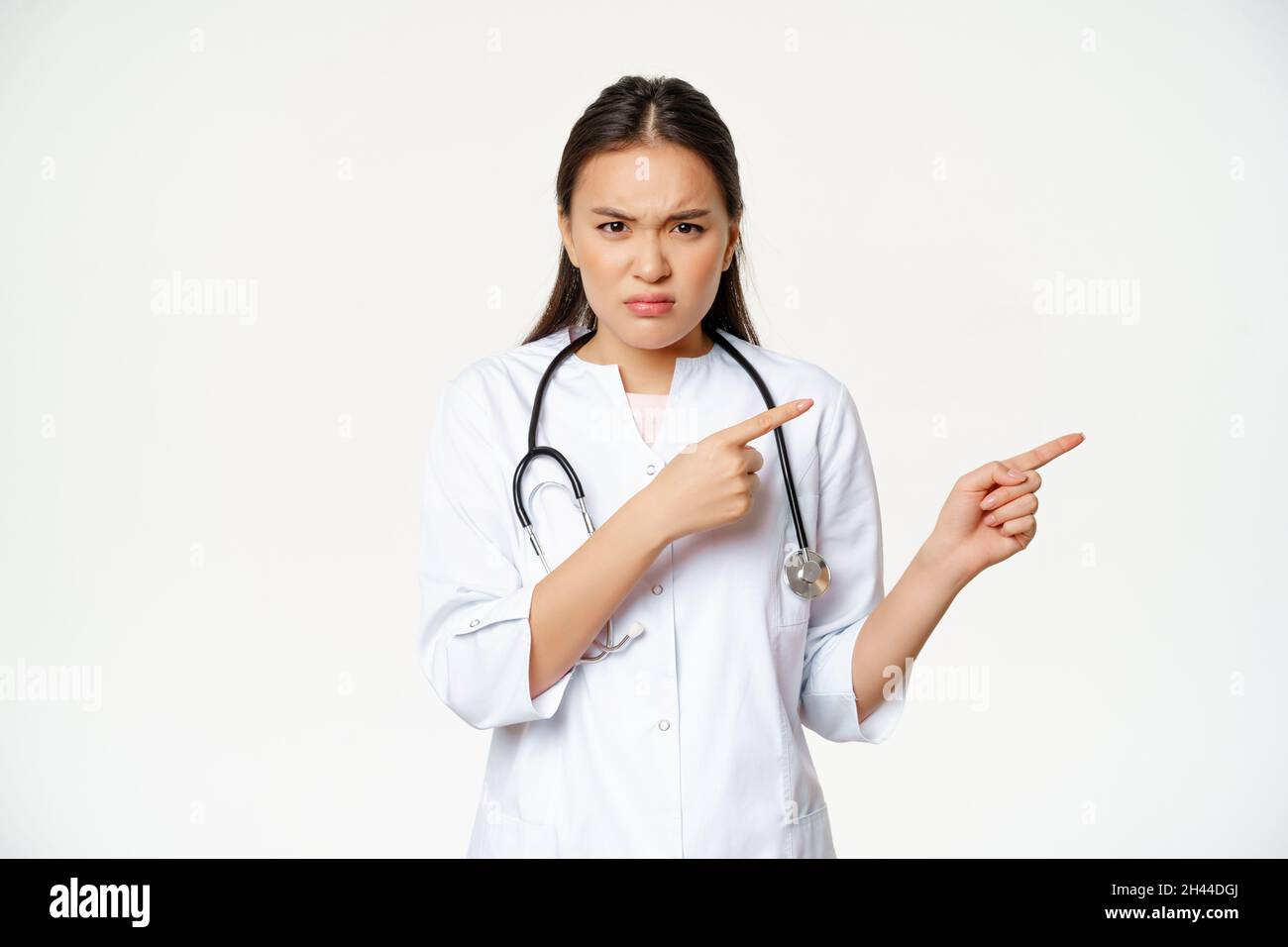 Angry female doctor, asian physician in medical robe and stethoscope ...