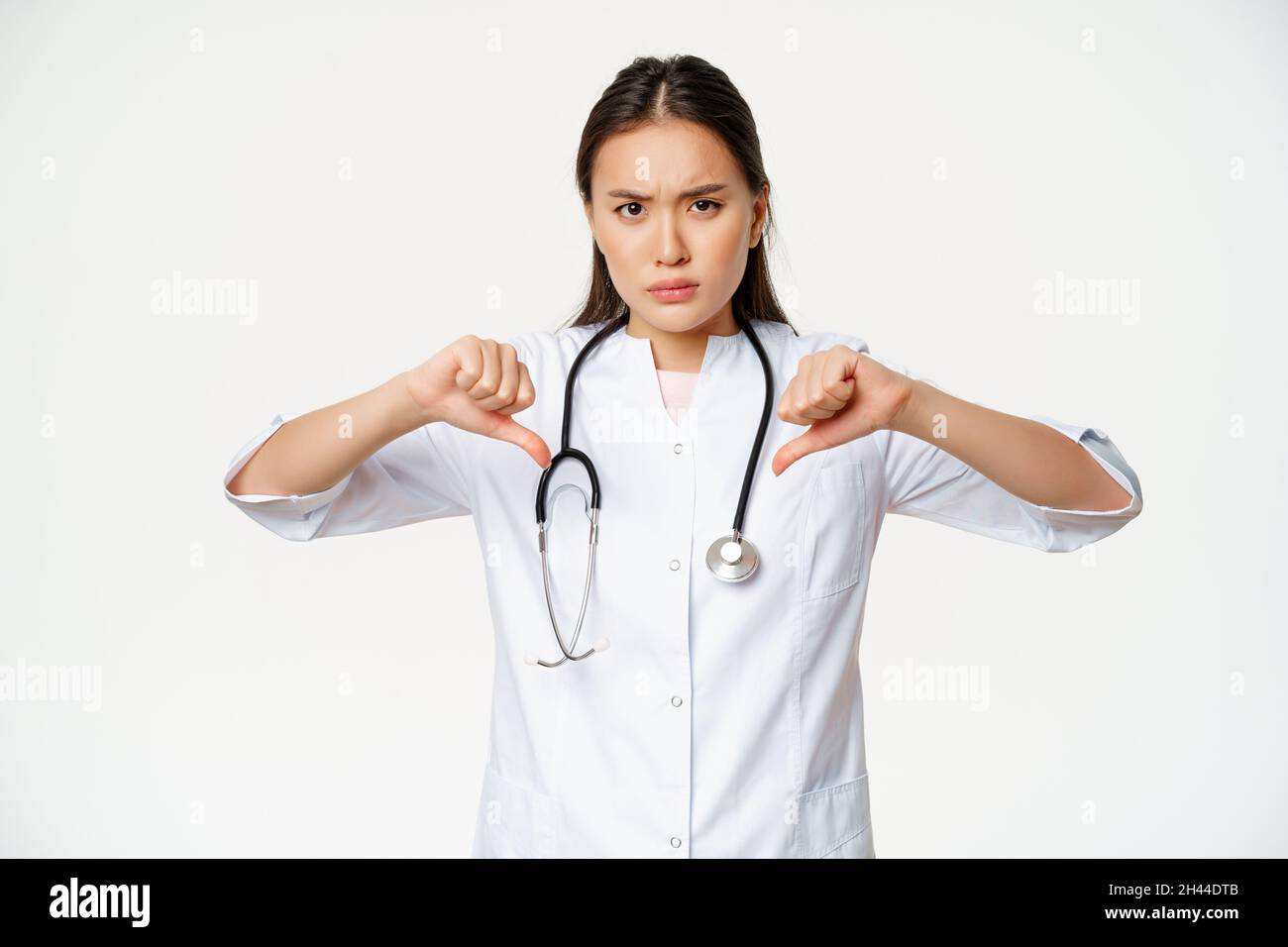 Disappointed serious-looking asian female doctor, hospital physician ...