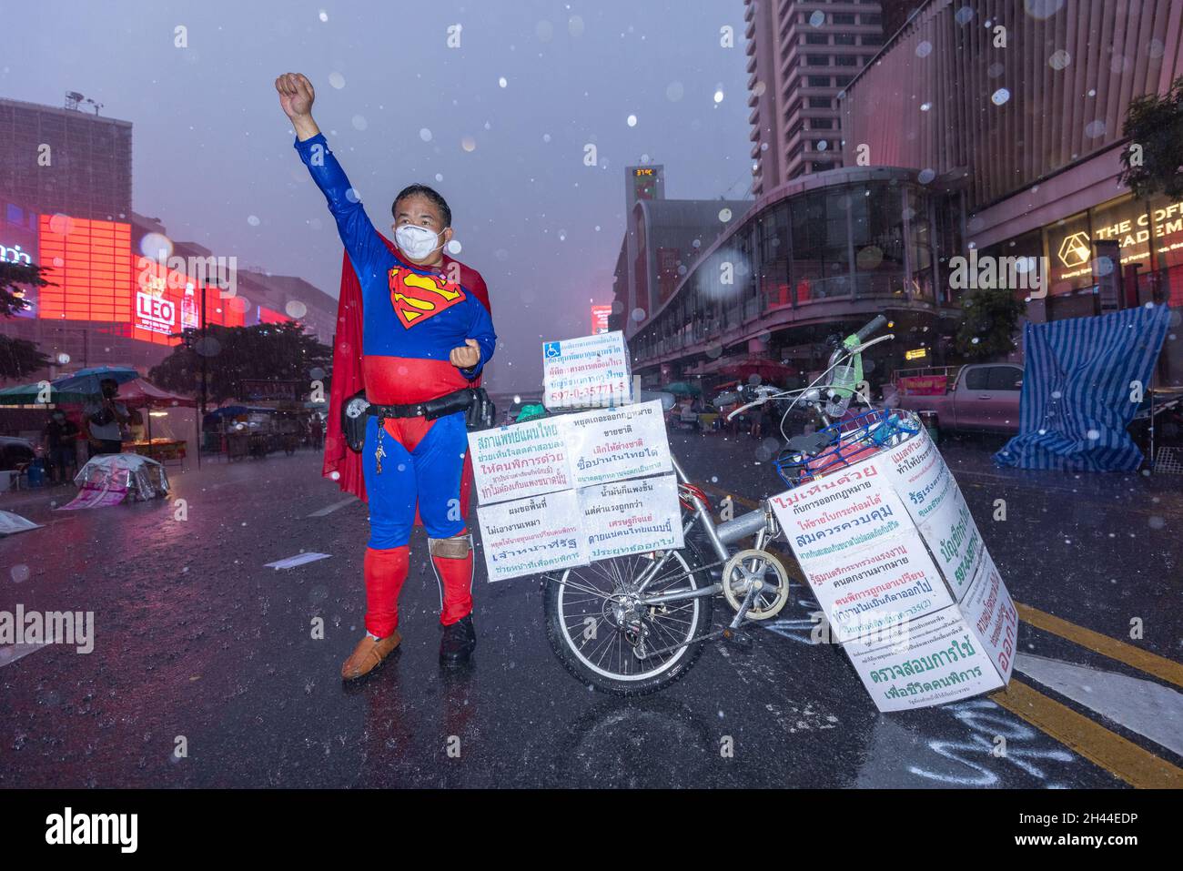 A protester in Superman suit poses for a photo in the rain during the ...