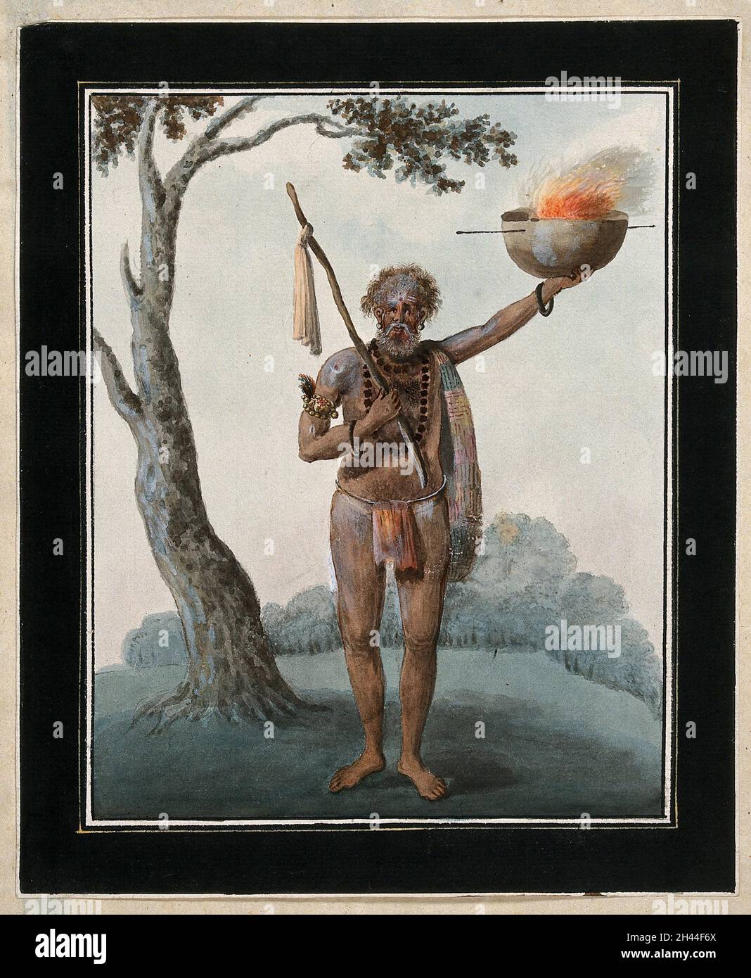 A fakir (mendicant monk) or holy man, holding up a bowl of fire ...