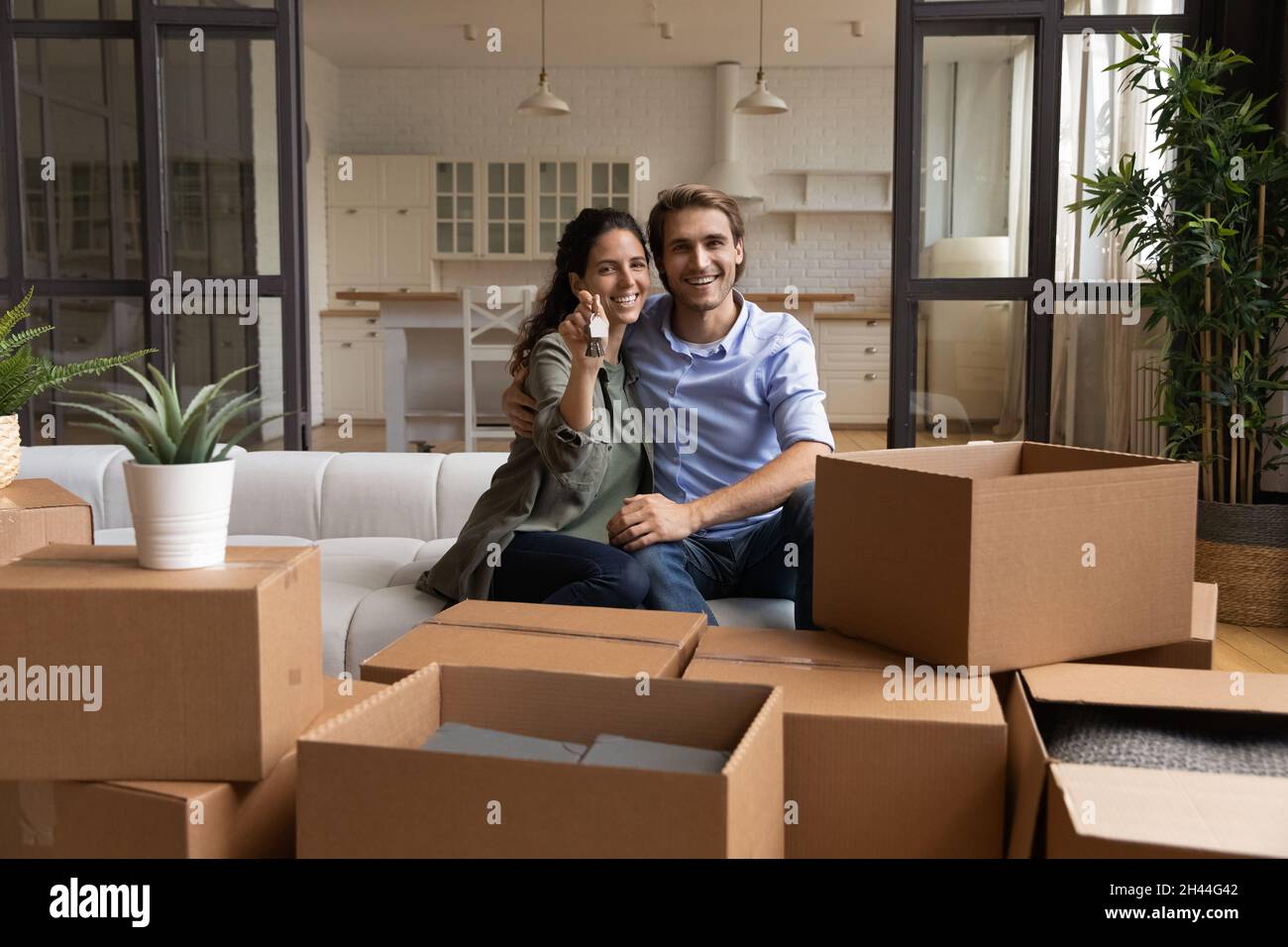 Happy couple showing bunch of keys enjoy relocation day Stock Photo - Alamy