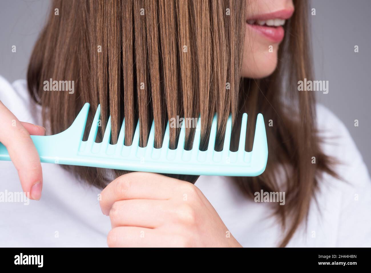 Close up brushing hair with comb. Combing long hair with hairbrush ...