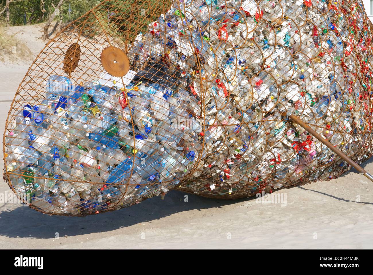 dumpster in the form of a huge fish with garbage inside Stock Photo - Alamy
