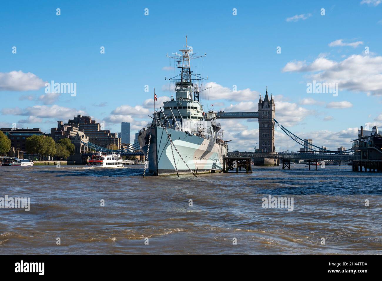 October 2021: HMS Belfast warship on the River Thames and the Tower of ...