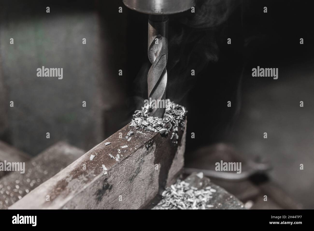 Thick drill drilling old iron bar, steel work equipment close-up Stock ...