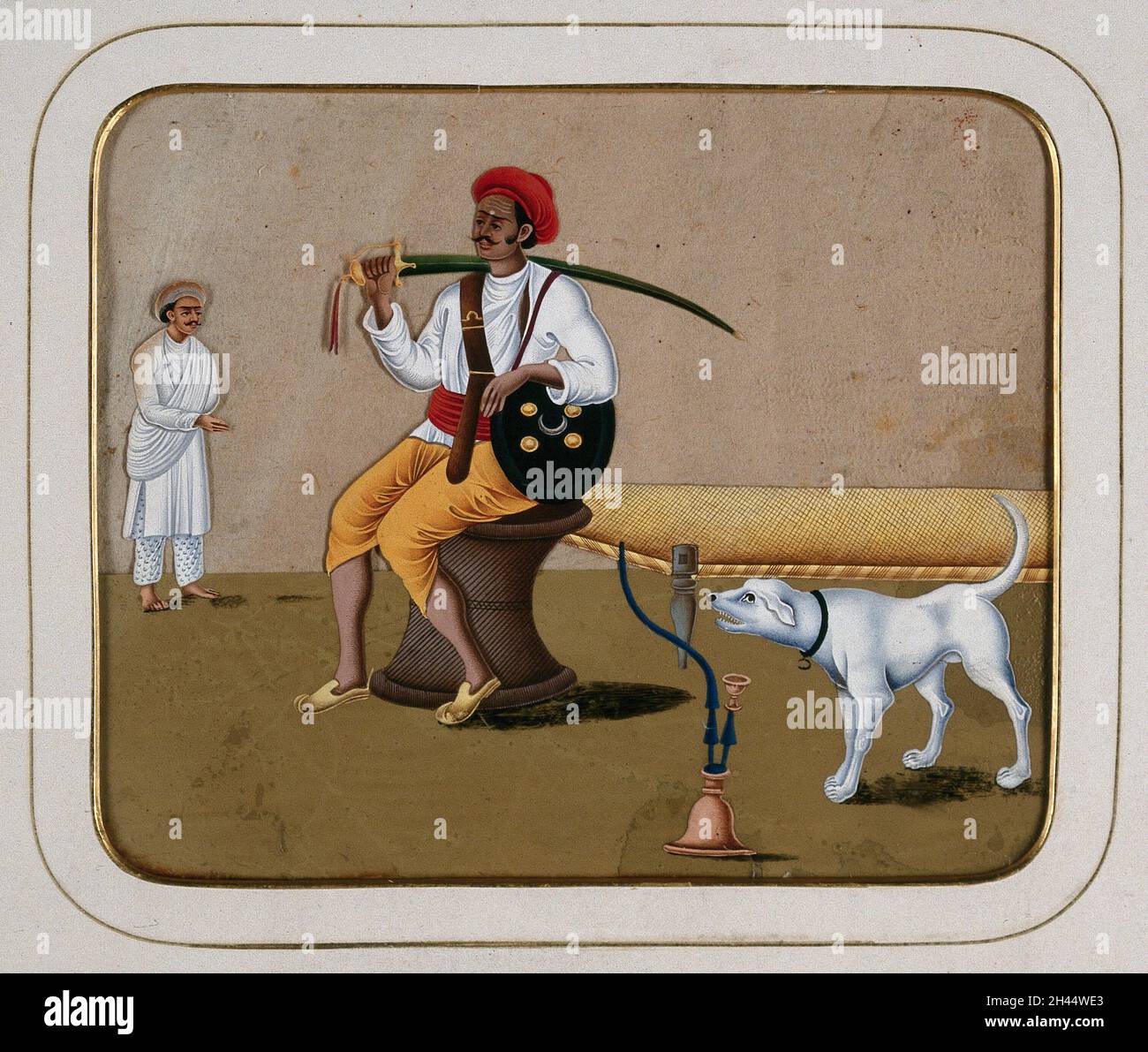 A dog growling at a soldier sitting on a muda (stool), next to a bed ...