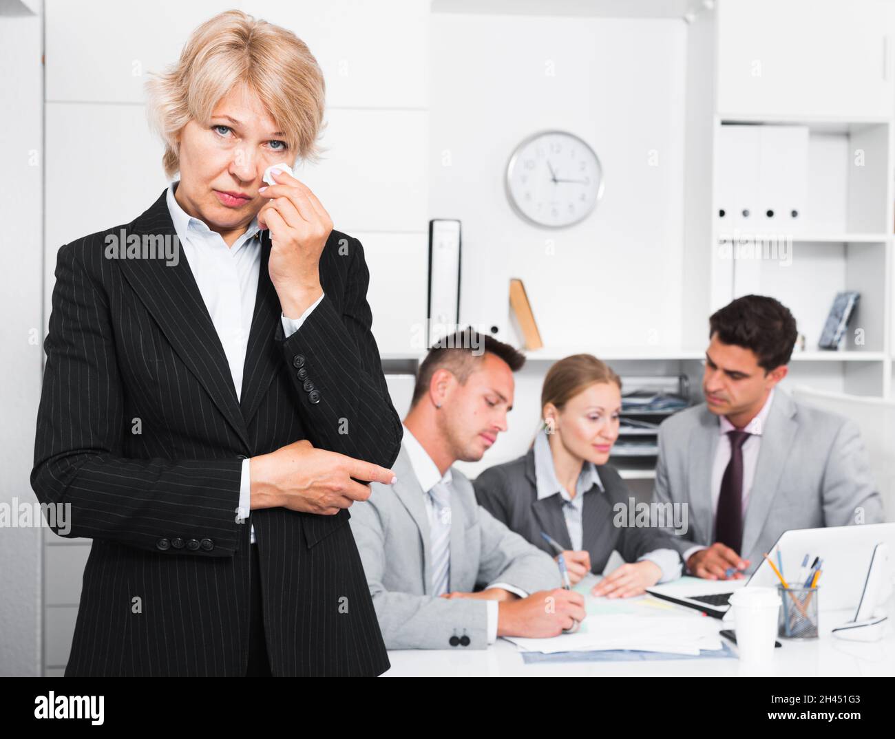 Business woman crying in office with working colleagues Stock Photo - Alamy
