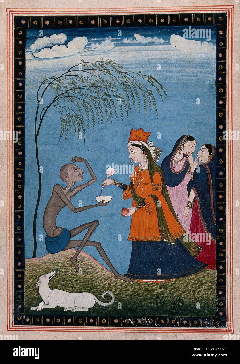 An emaciated Hindu ascetic or holy man, seated on a knoll under a tree ...