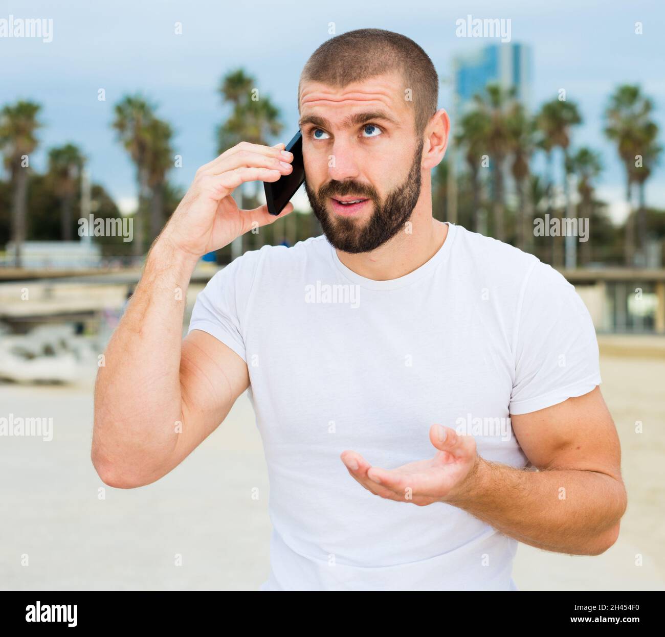 Happy young sportsman talking mobile hi-res stock photography and ...