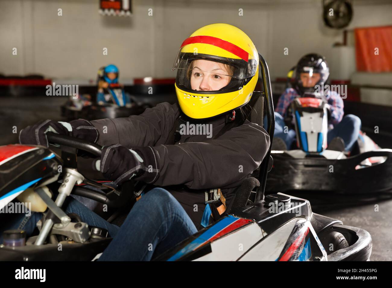 Female racer in helmet driving kart on track Stock Photo - Alamy