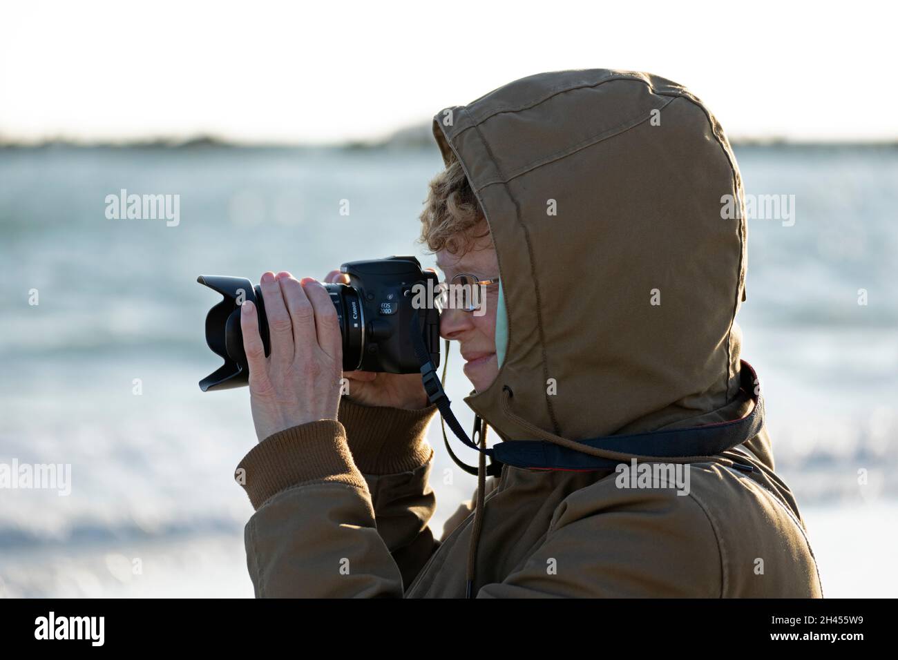 Woman taking photos, Düne, Heligoland Island, Schleswig-Holstein ...