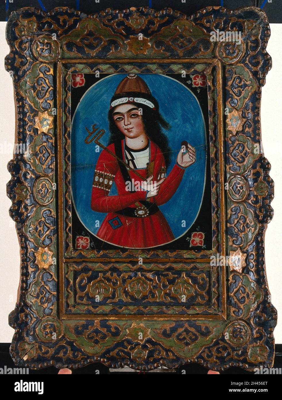 A young man holding a rod with a shaped end (sceptre?) and a round ...