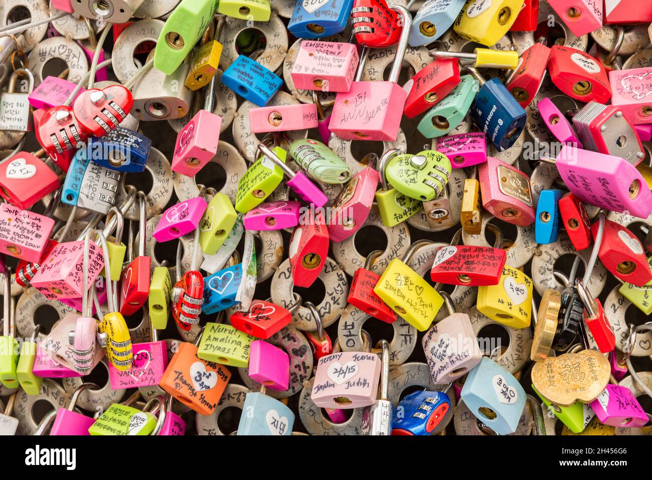 A wall full of padlocks of many shapes and colors on a street in Seoul ...